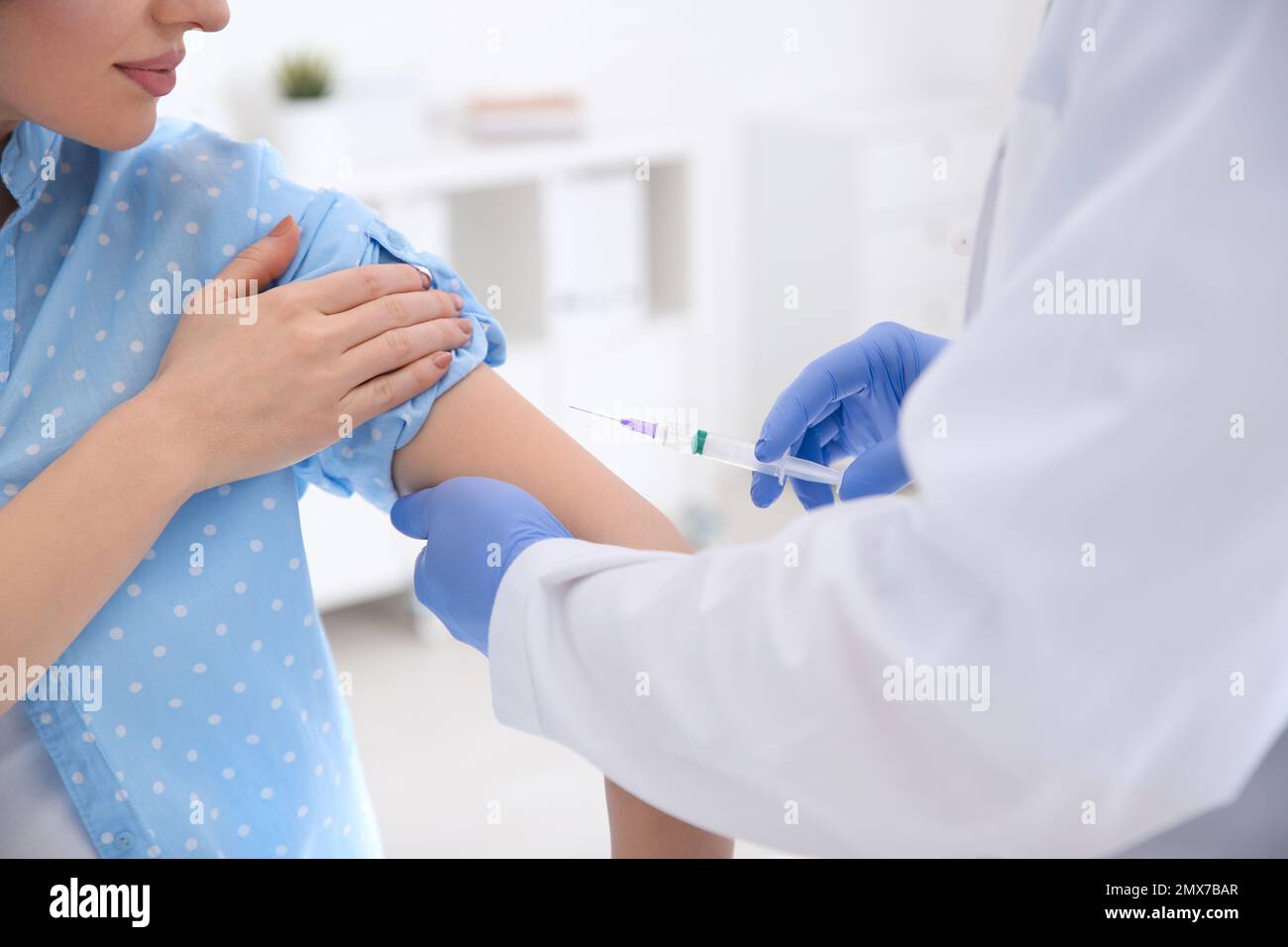 Doctor giving injection to patient in hospital, closeup. Vaccination ...