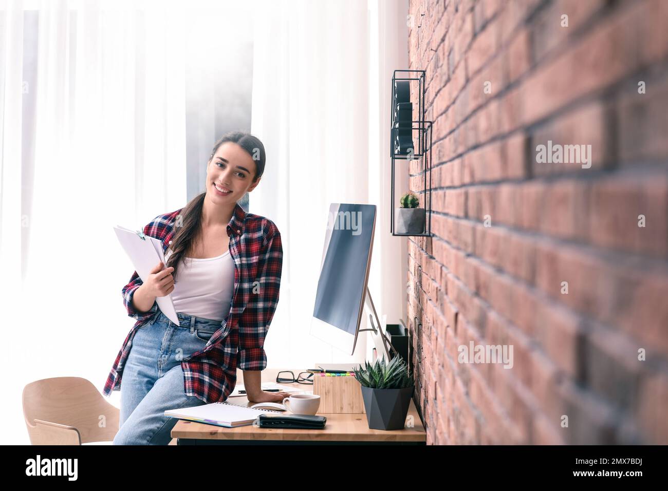 Professional journalist with papers at workplace in light office Stock ...