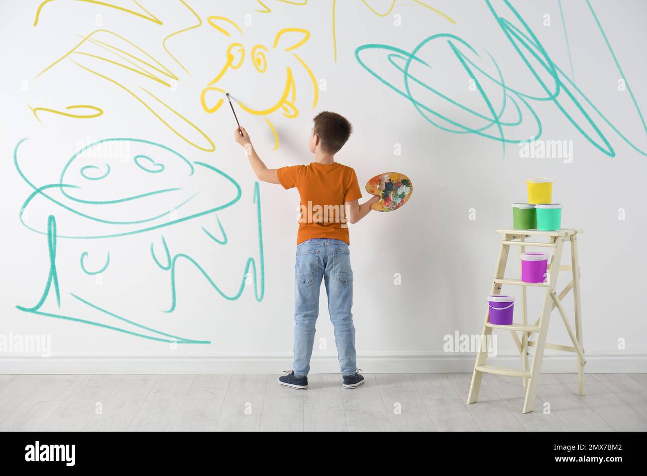 Little child drawing scribbles on white wall indoors Stock Photo - Alamy