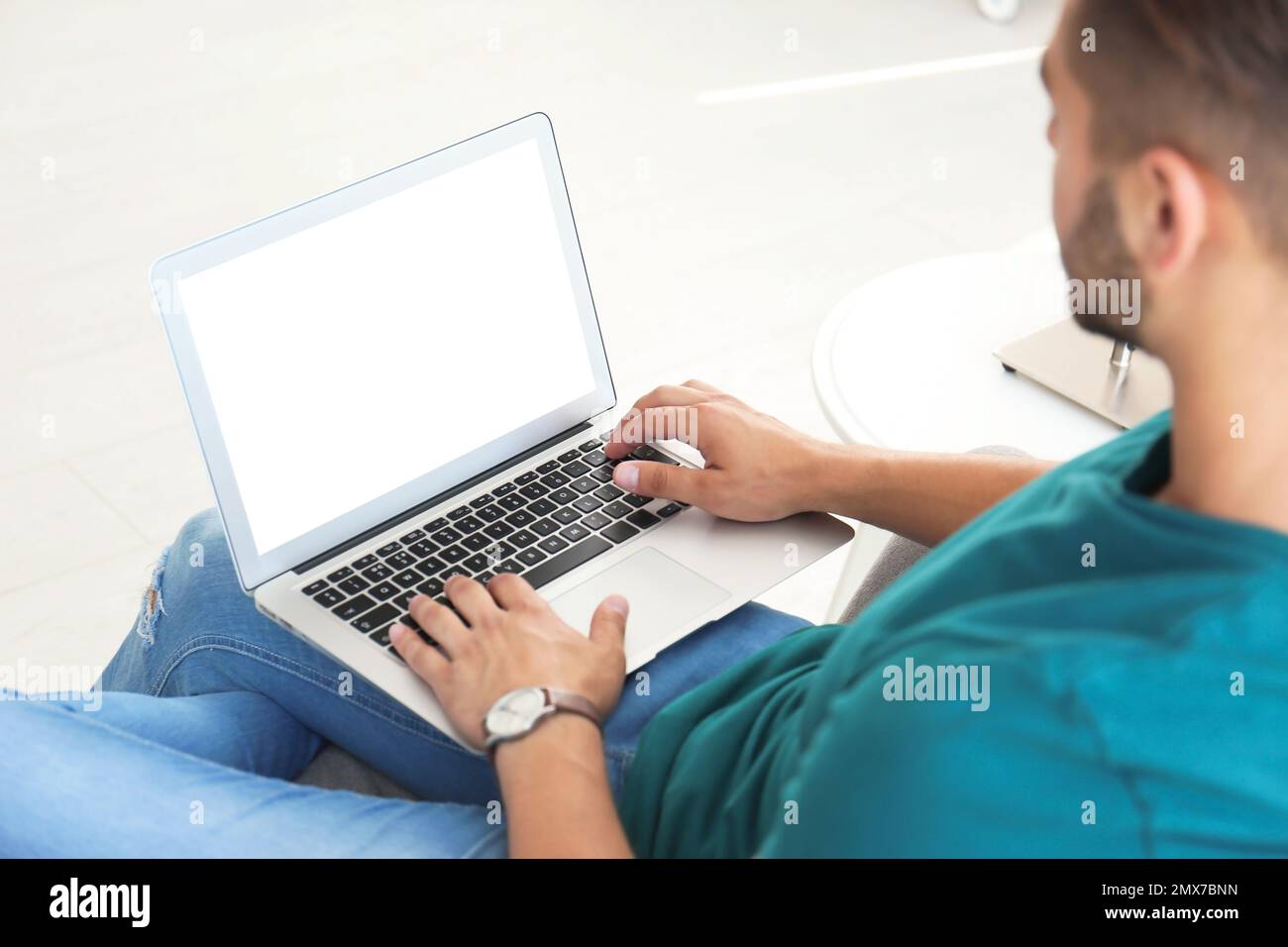 Young man using modern computer at home, focus on hands. Space for ...