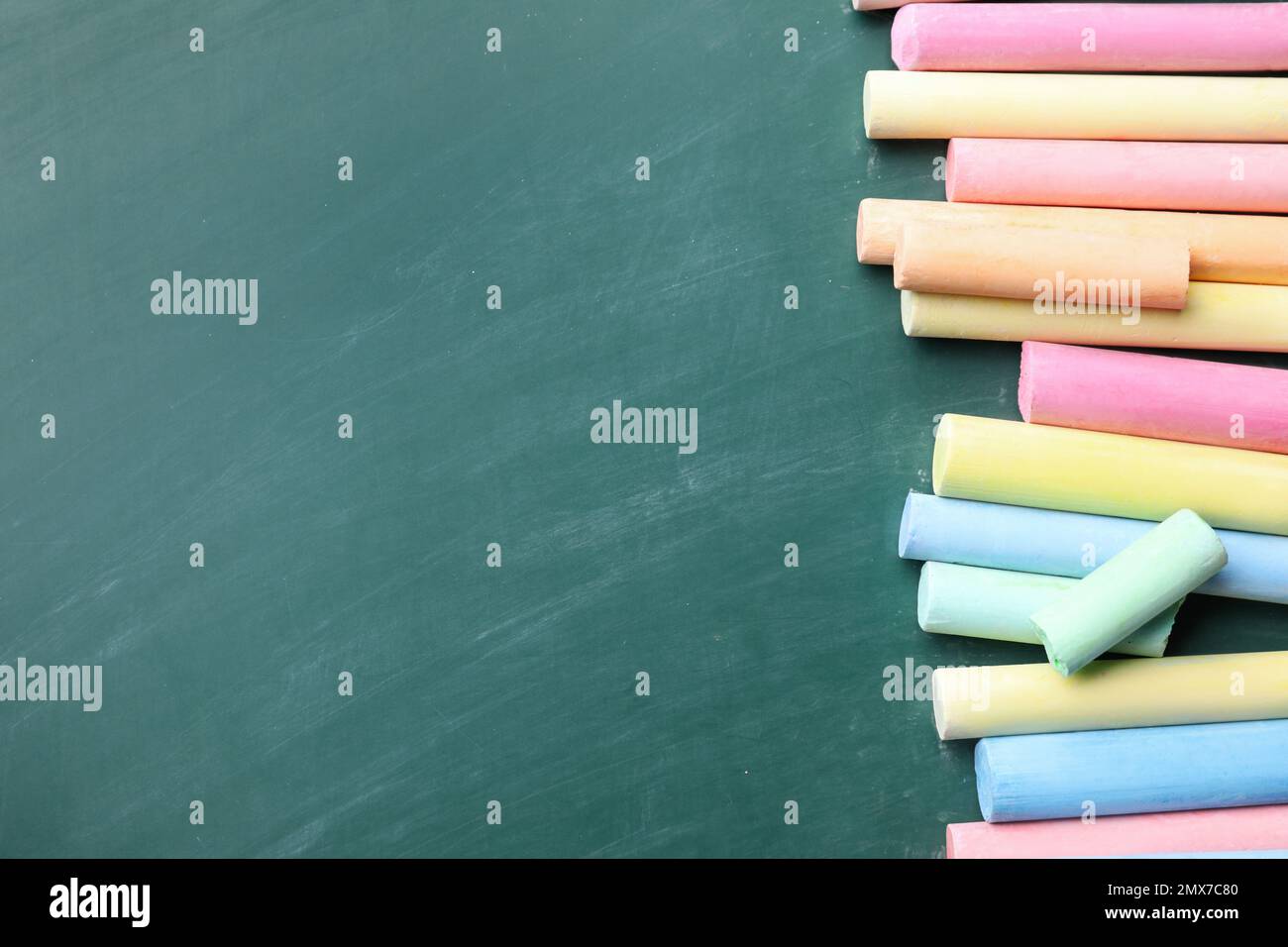 Pieces of color chalk on greenboard, flat lay. Space for text Stock ...