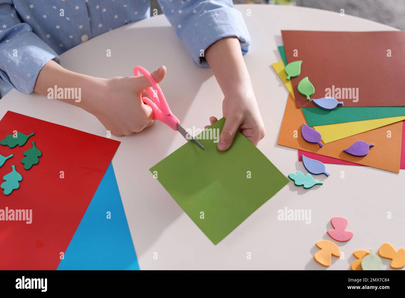 Little girl making greeting card at table indoors, top view. Creative ...