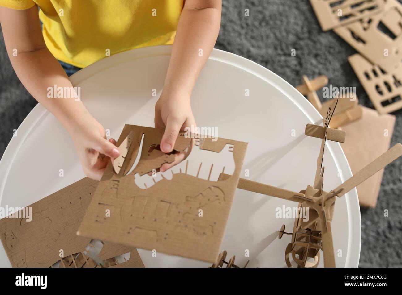 Little boy making carton toys at table indoors, top view. Creative ...