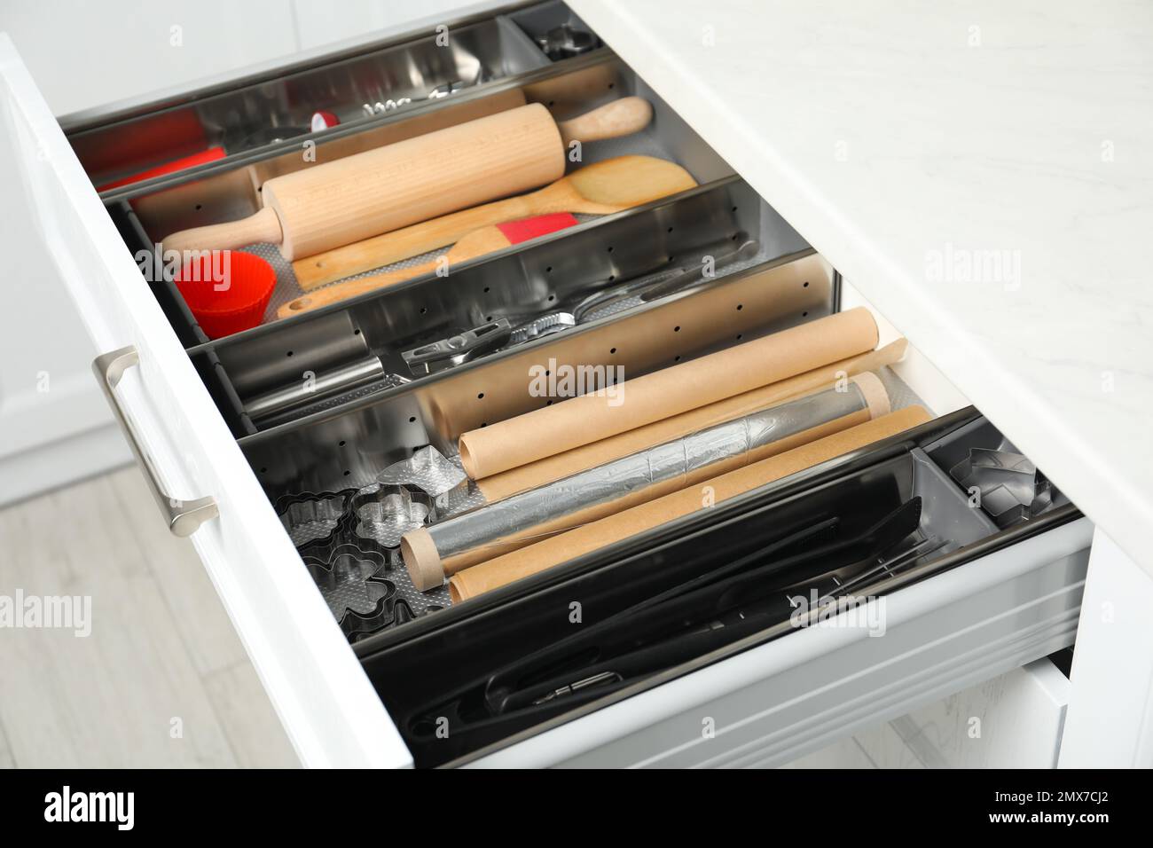 Different utensils in open desk drawer indoors Stock Photo - Alamy
