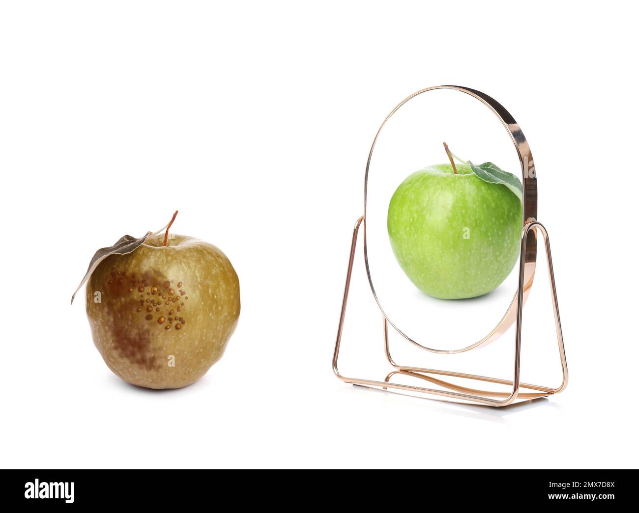 Spoiled apple and mirror with reflection on white background Stock ...