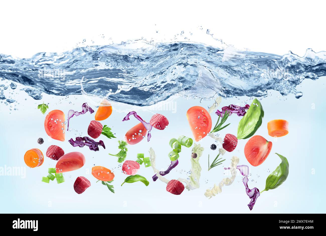 Many different ingredients in water with splashes. Soup recipe Stock ...