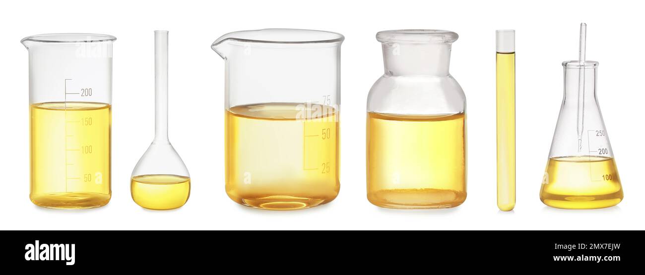Set of laboratory glassware with yellow liquid on white background ...