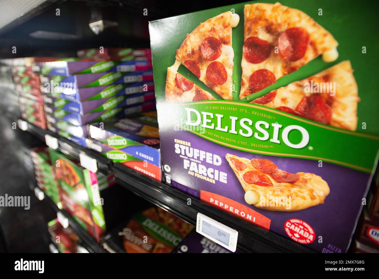 Delissio frozen pizzas are shown in the frozen food aisle at a grocery ...