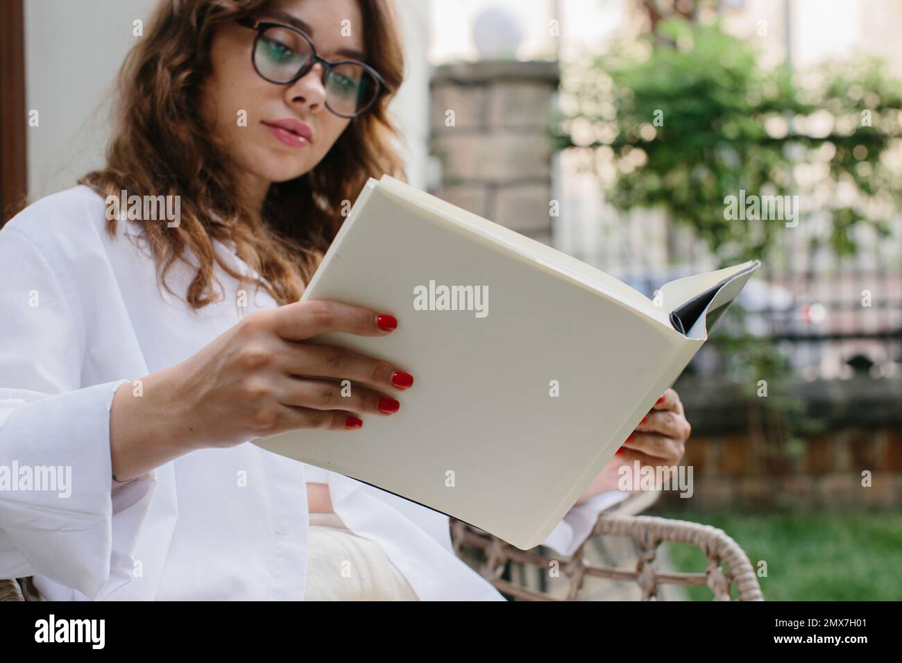 Mockup image magazine book. The girl at the coffee shop table reading ...