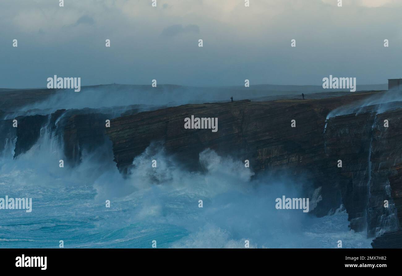 People walking on Yesnaby cliffs in winter storm, Orkney Islands Stock ...