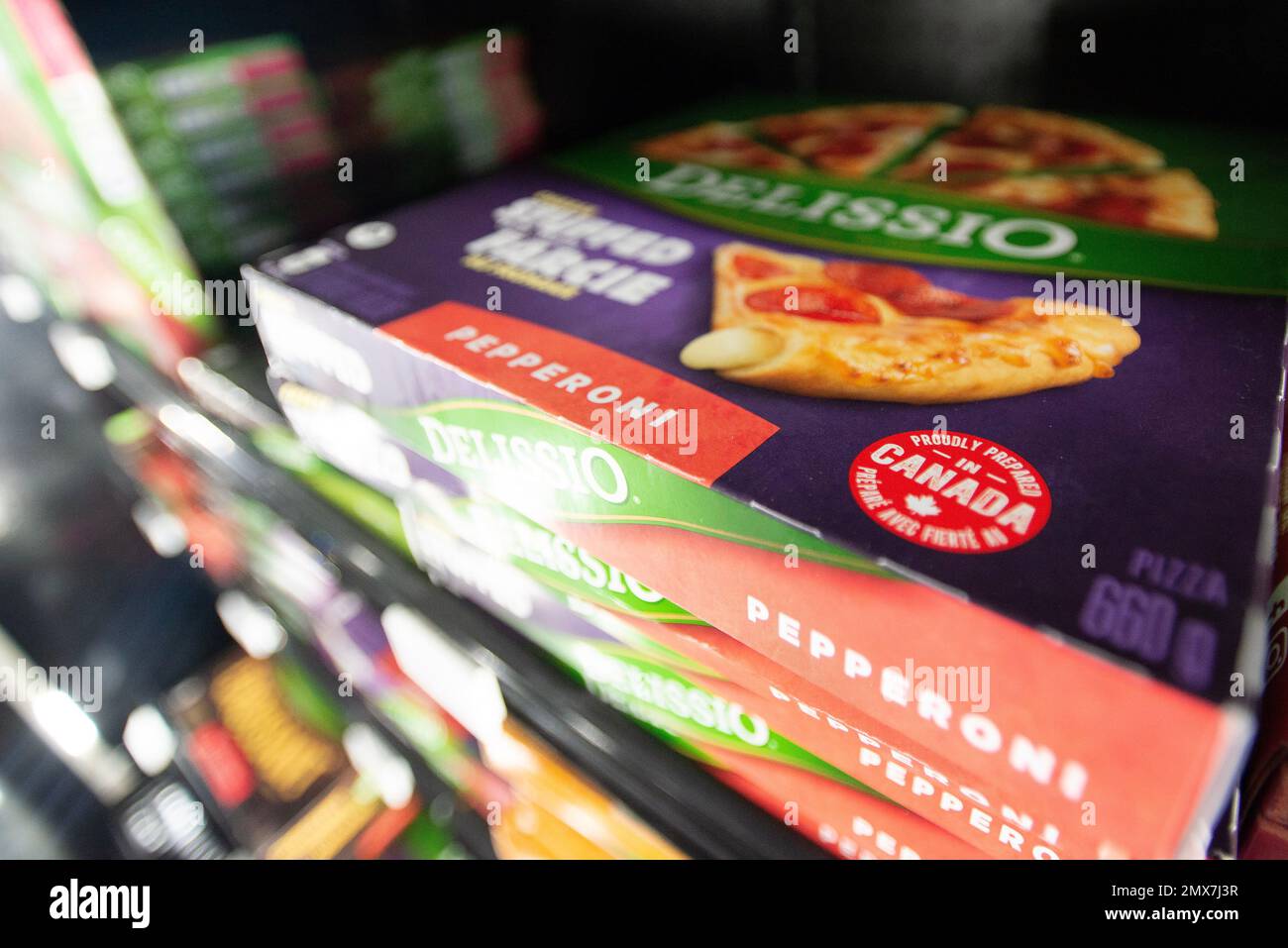 Delissio frozen pizzas are shown in the frozen food aisle at a grocery ...
