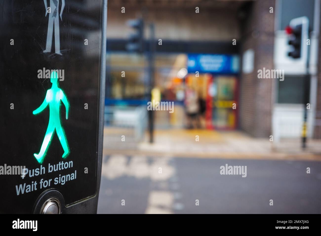 green figure of a man on a crossing point to indicate to pedestrians ...