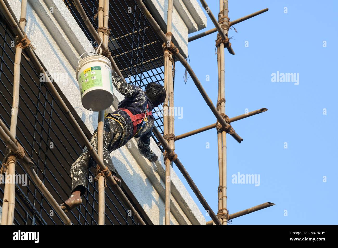 INDIA, Mumbai, apartment tower under renovation, bamboo scaffold ...