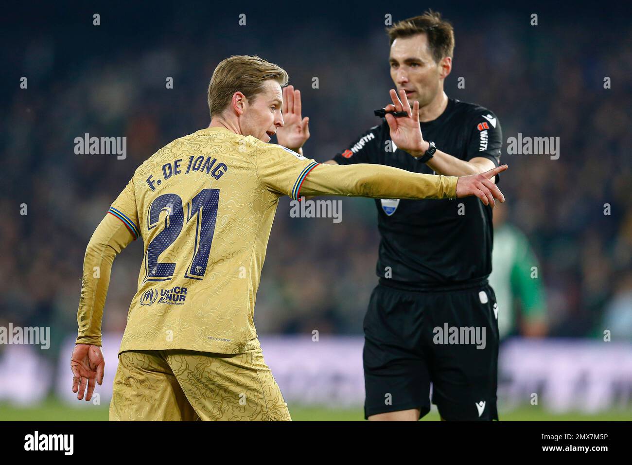 Frenkie de Jong of FC Barcelona and The referee Ricardo de Burgos ...