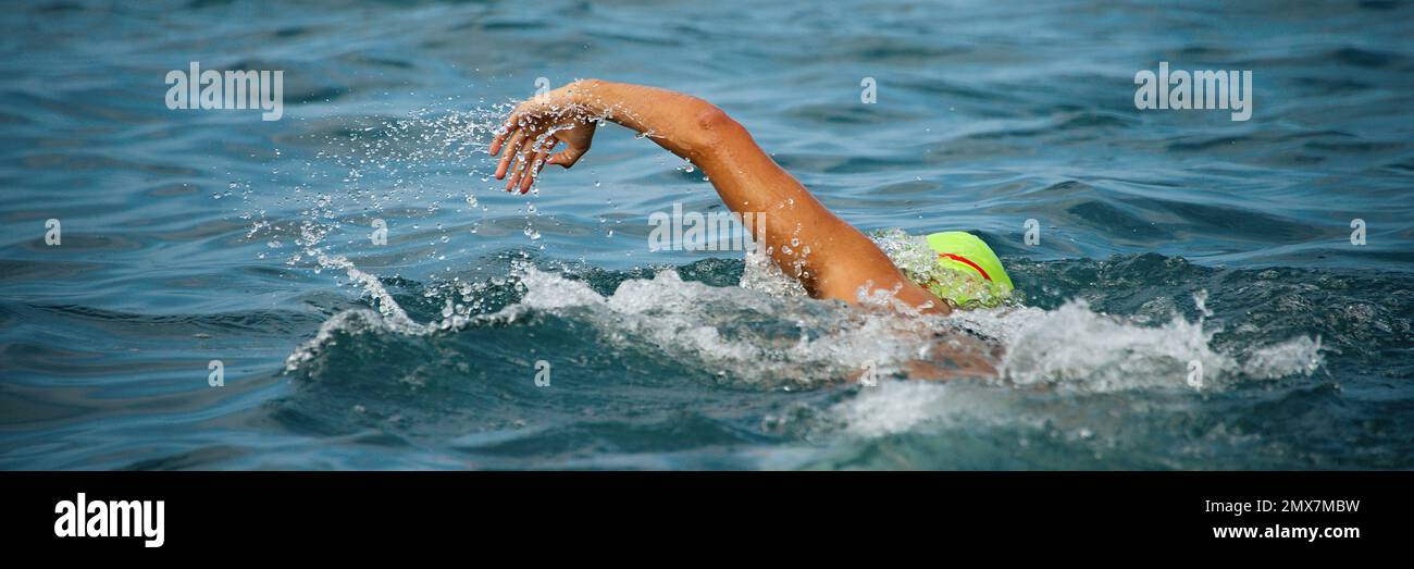 Triathlete woman swimming freestyle crawl in ocean, female triathlon ...