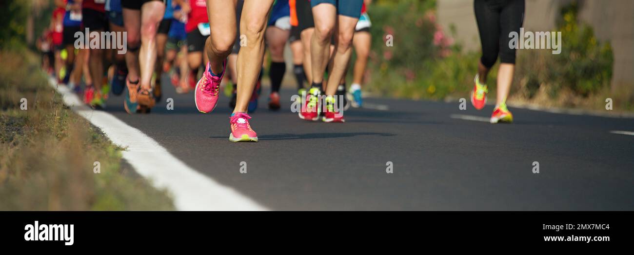 Marathon runners running on city road, large group of runners Stock ...