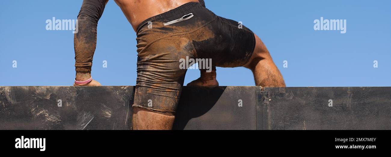Mud race runners running over obstacles extreme sport Stock Photo - Alamy