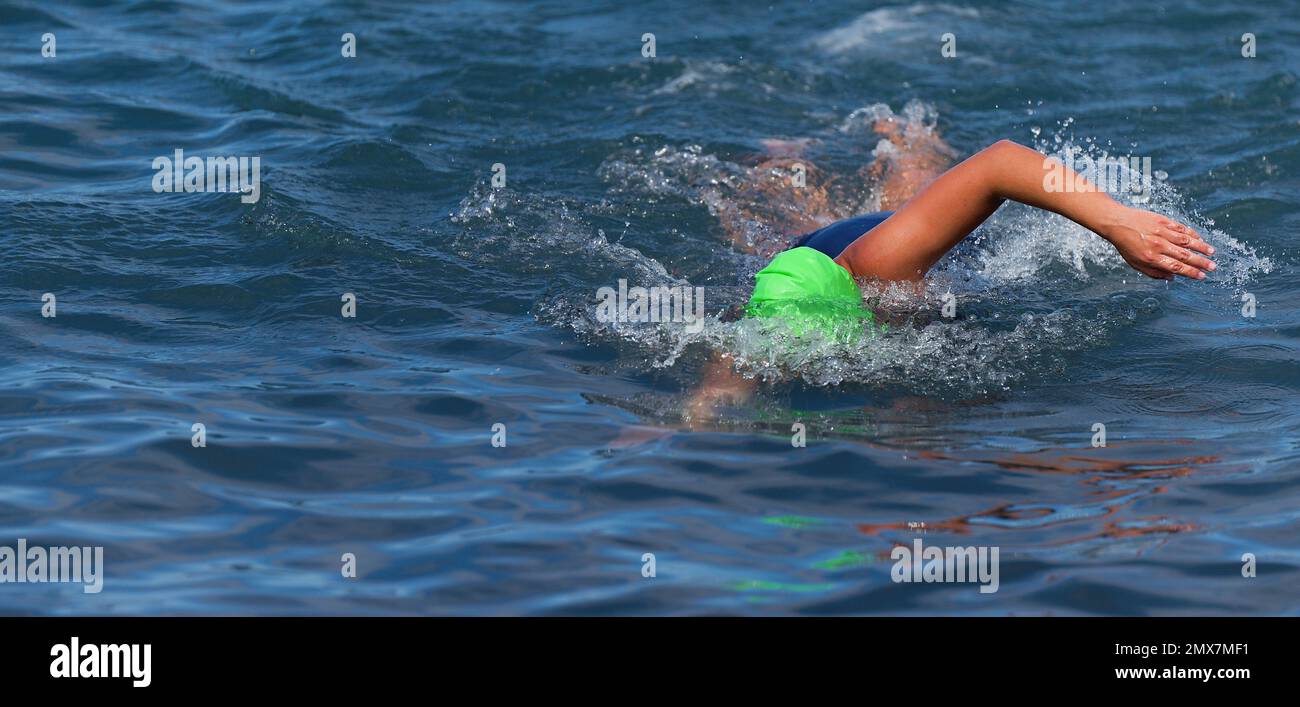 Triathlete woman swimming freestyle crawl in ocean, female triathlon ...