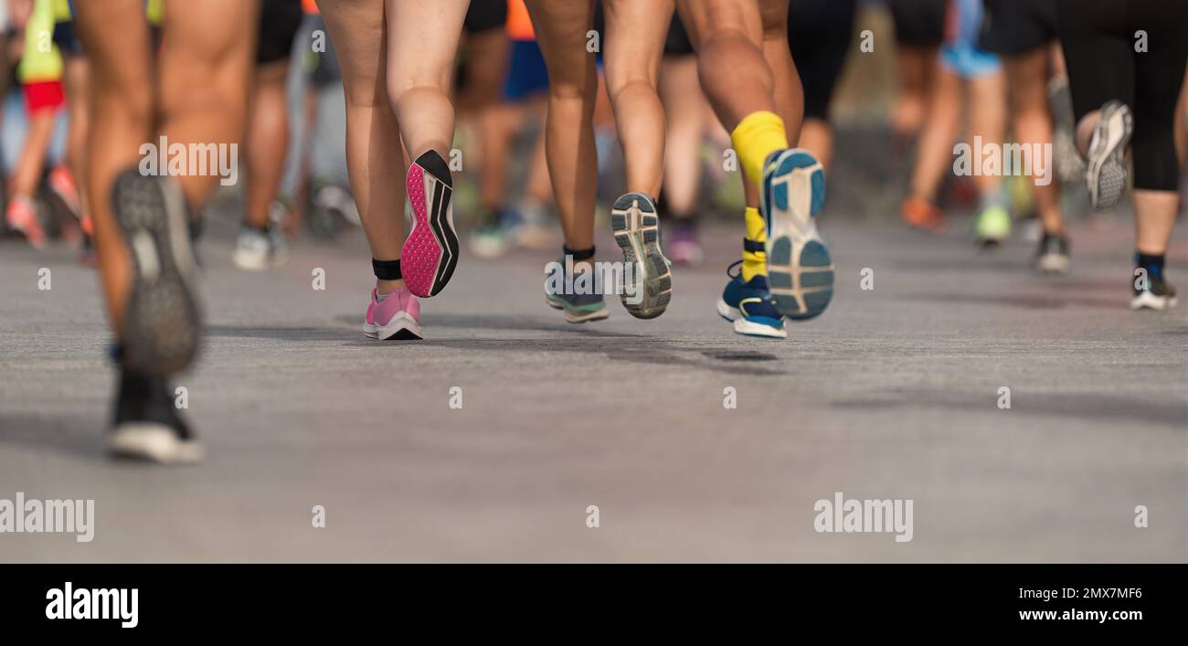 Marathon runners running on city road, large group of runners Stock ...