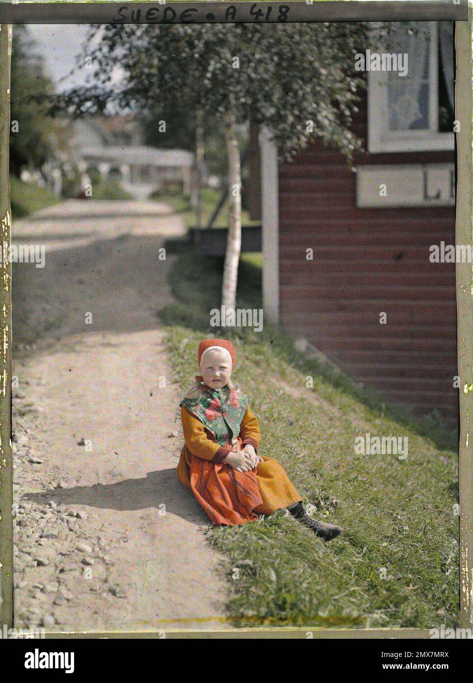 Leksand, Sweden Lisskulla (young Dalecarlian) sitting on the side of ...