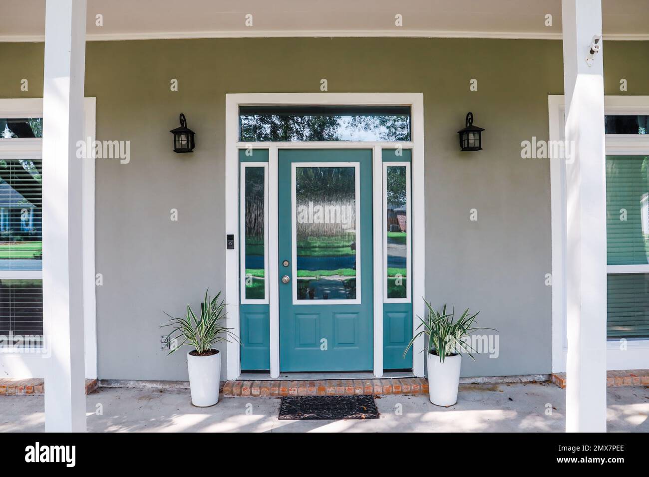 A simple walkway to an Acadia style gray house with a turquoise door ...