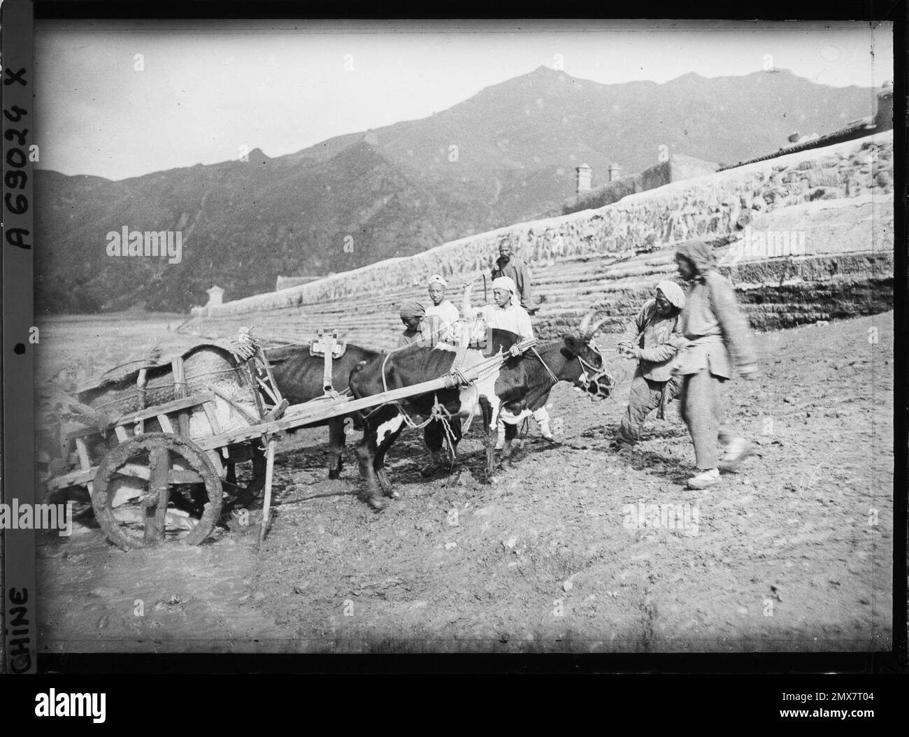 Surroundings of Kalgan, China Peasants pushing a cart pulled by Boys ...