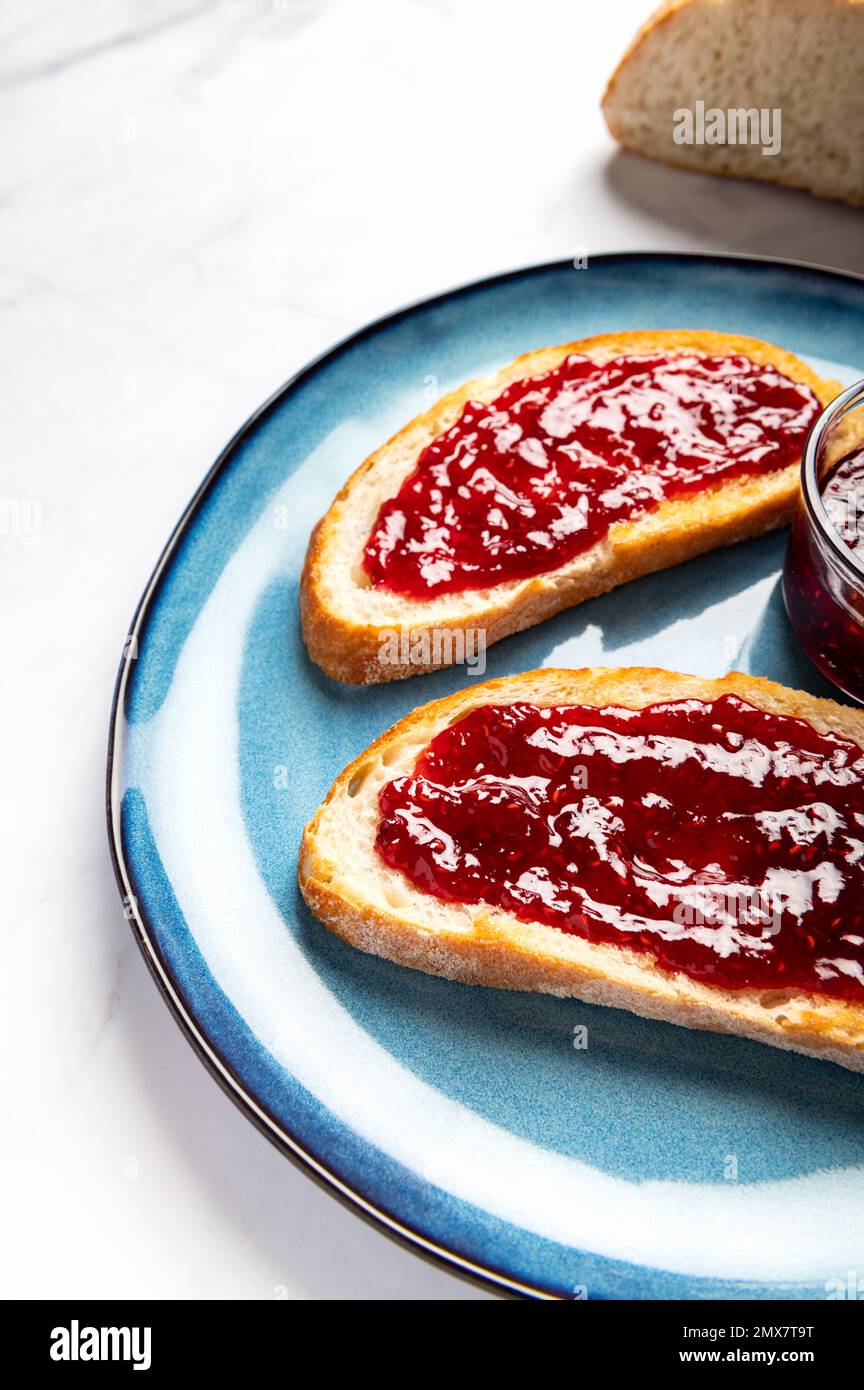 Raspberry jam on toast Stock Photo - Alamy