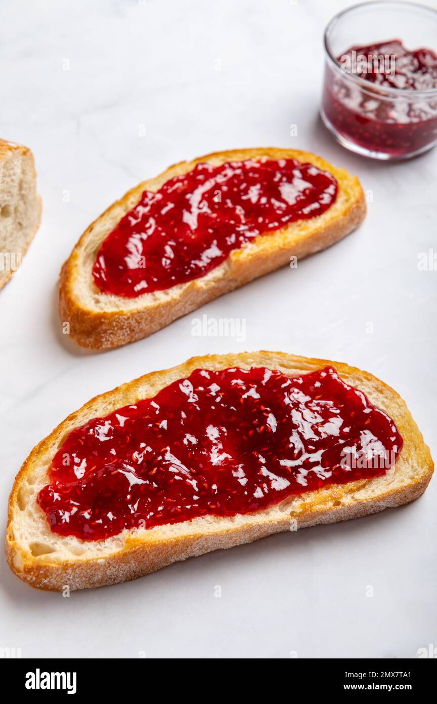Raspberry jam on toast Stock Photo - Alamy