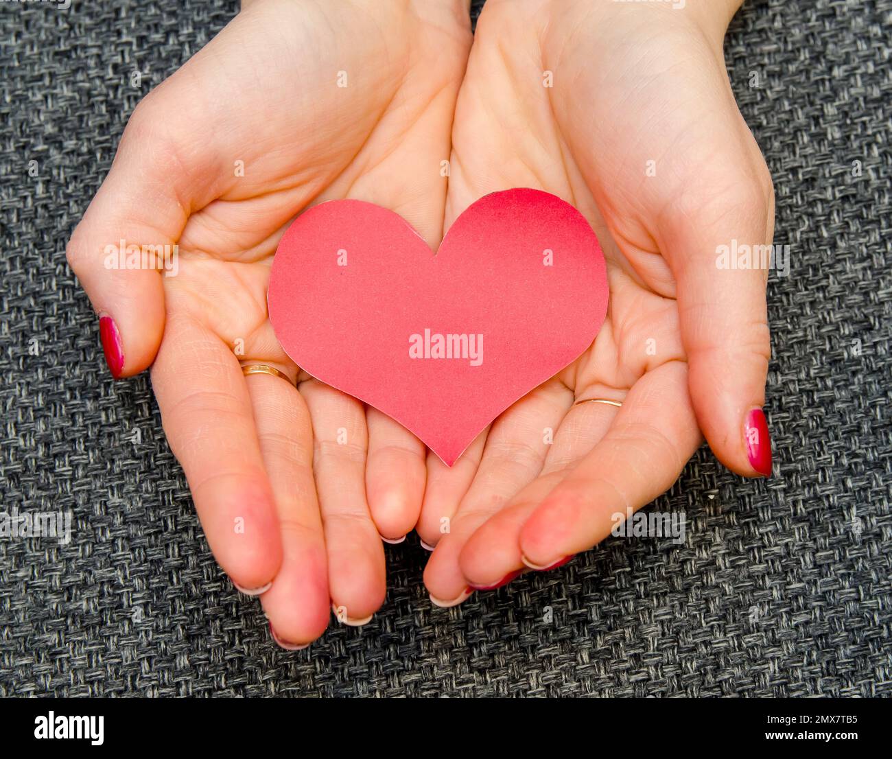 paper hearts on woman hand Stock Photo - Alamy