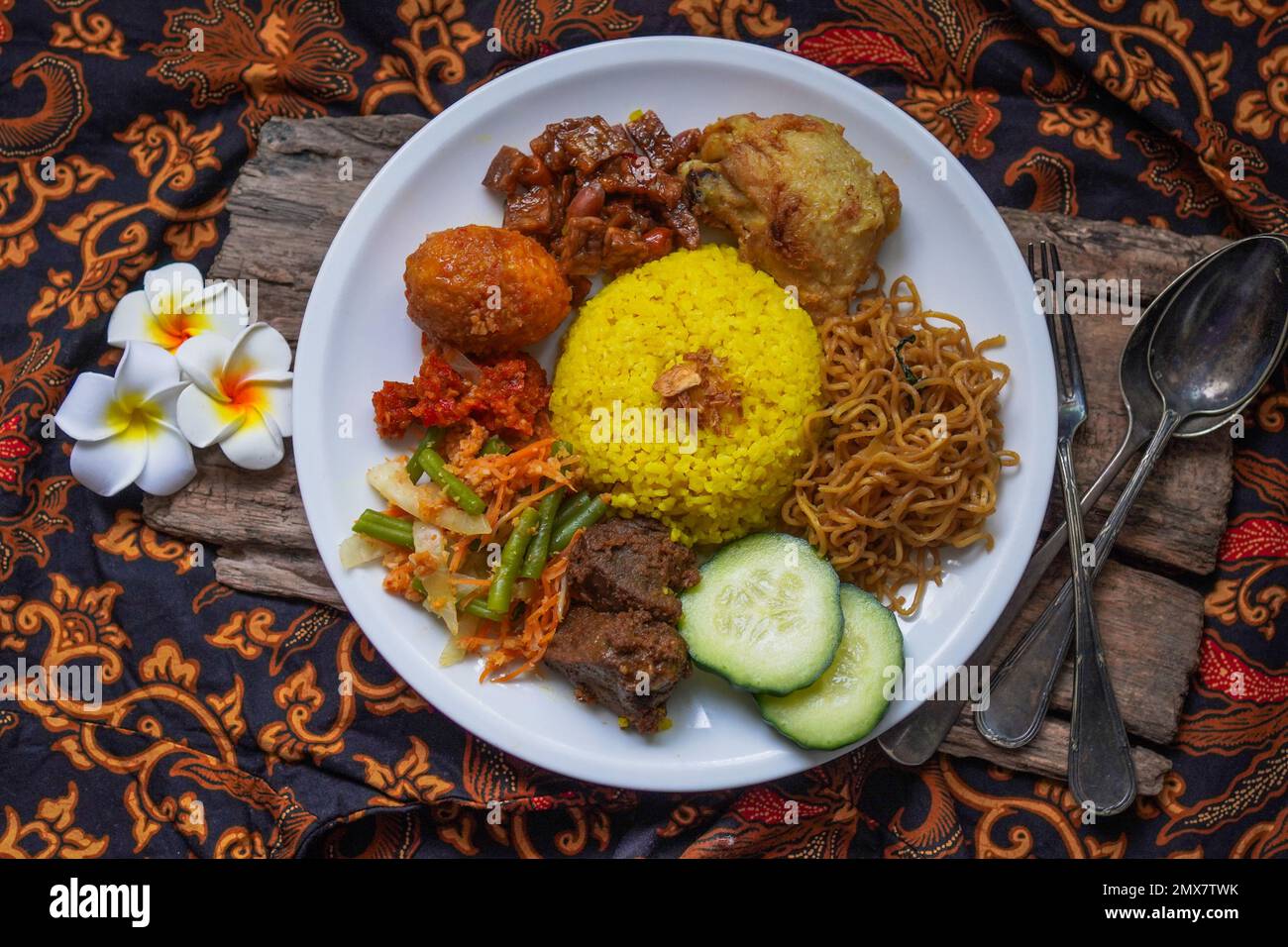 Indonesian traditional food, nasi kuning / yellow turmeric rice served ...