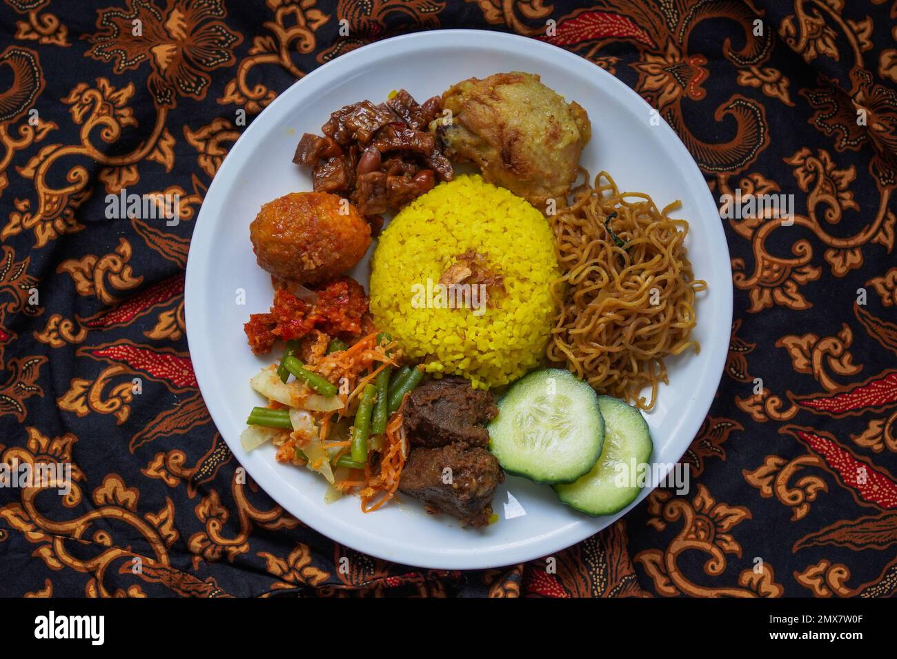 Indonesian traditional food, nasi kuning / yellow turmeric rice served ...