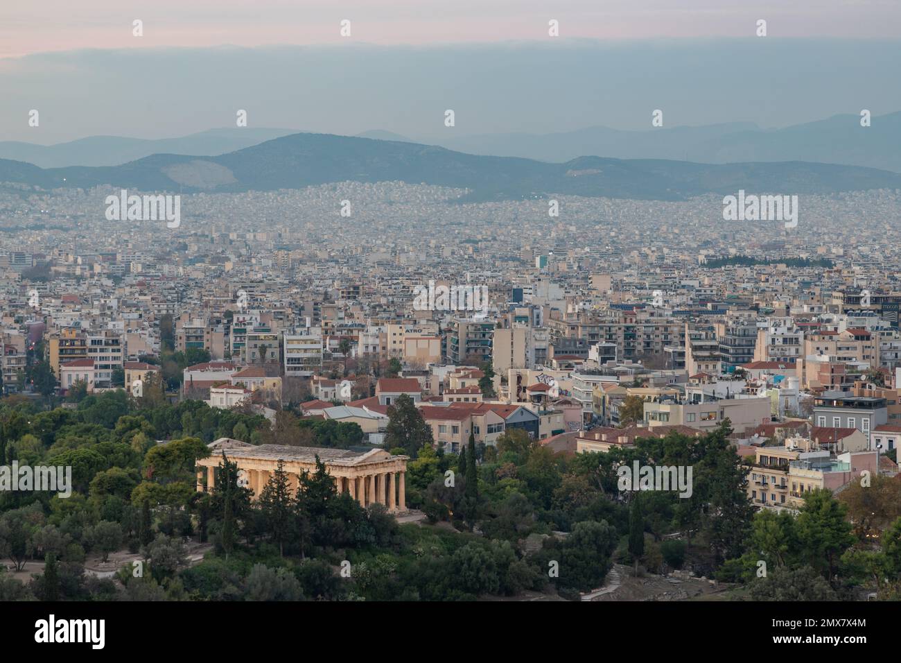 A picture of the Temple of Hephaestus and the city of Athens at sunset ...