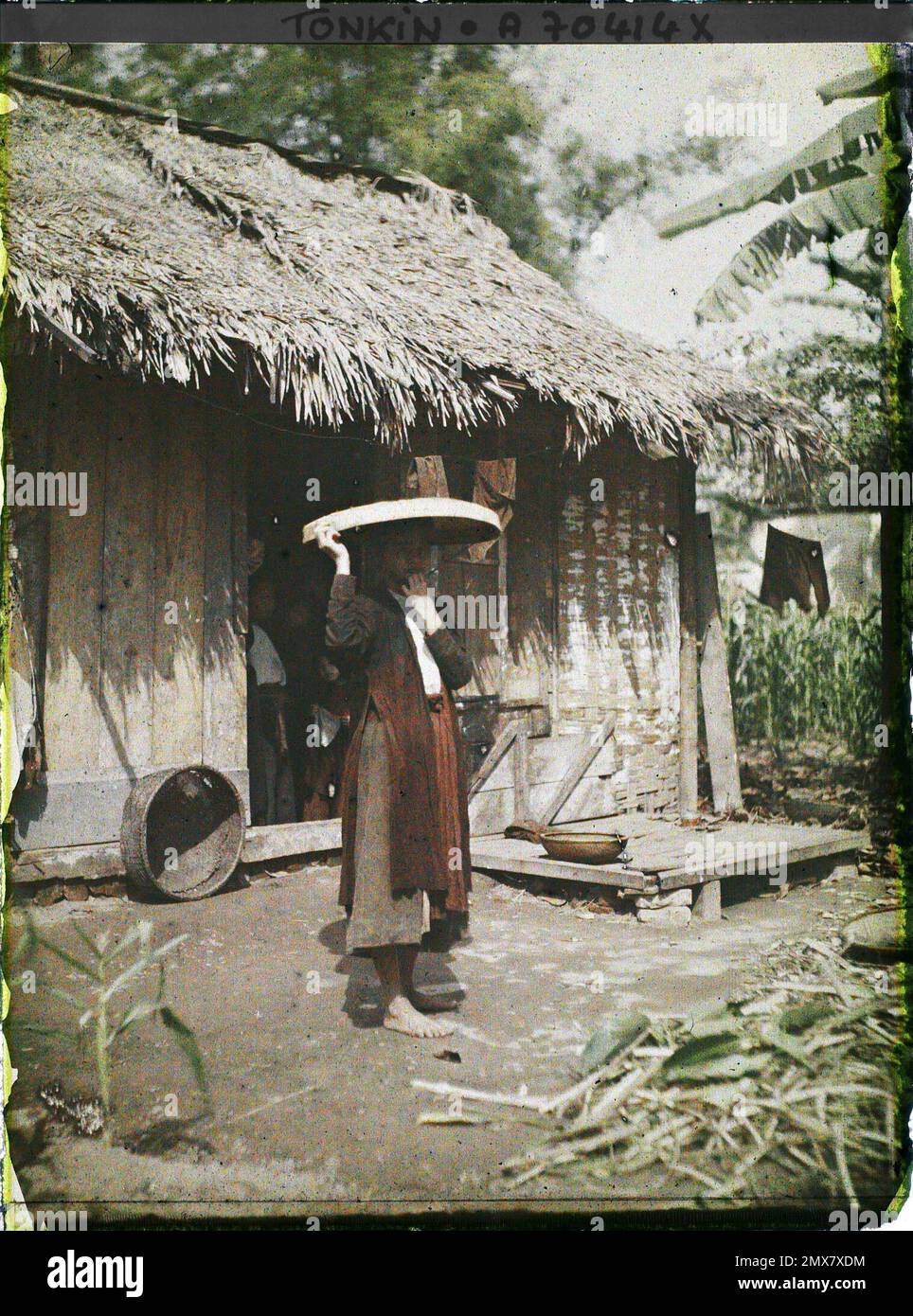 Tonkin, Indochina a young woman in front of a house , Léon Busy in ...