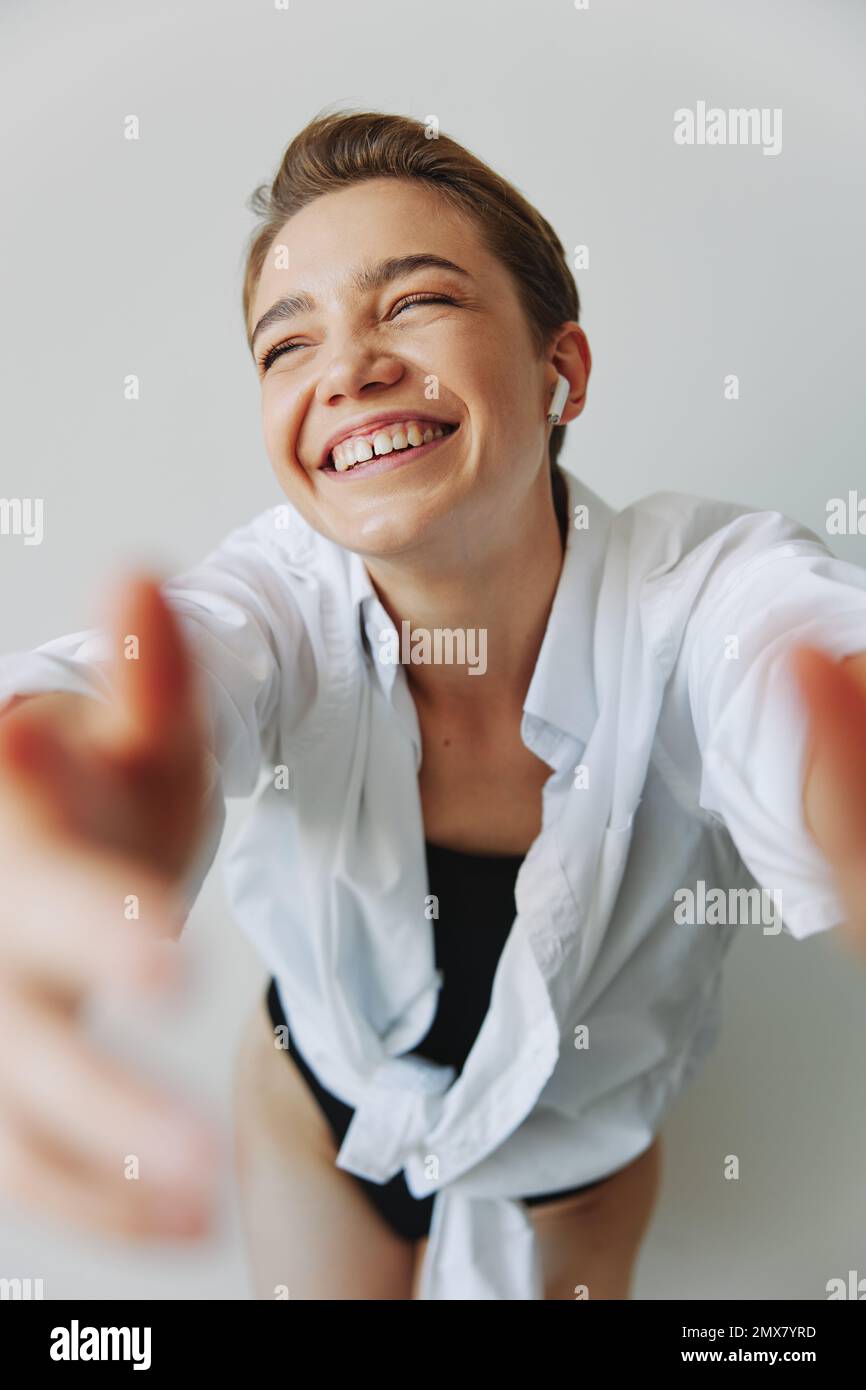Young woman teenager listening to music with infertile headphones and ...