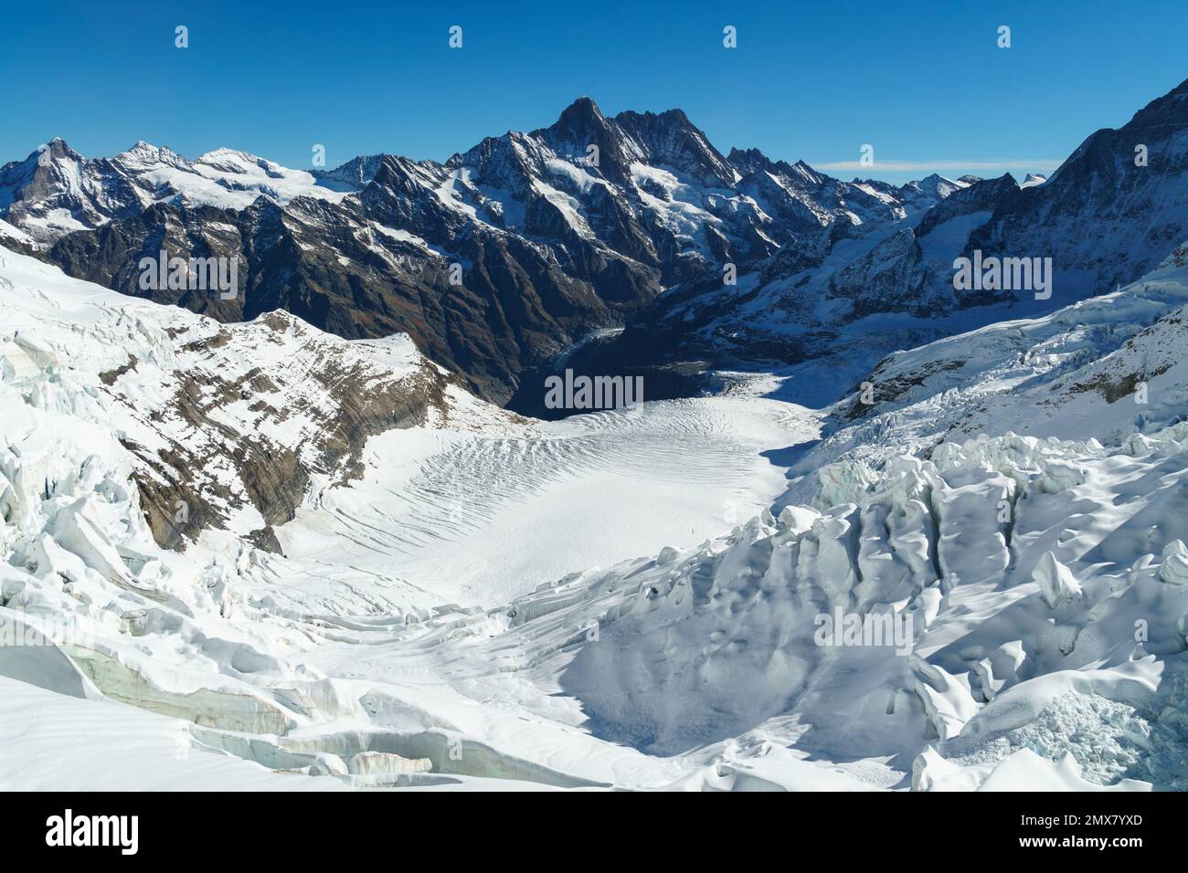 Snow, ice, and alpine ridges surround a glacial basin at Jungfraujoch ...