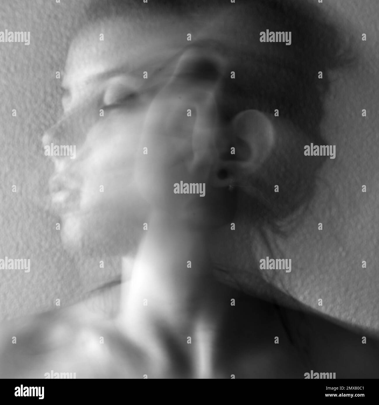 Double exposure black and white young female with closed eyes while ...