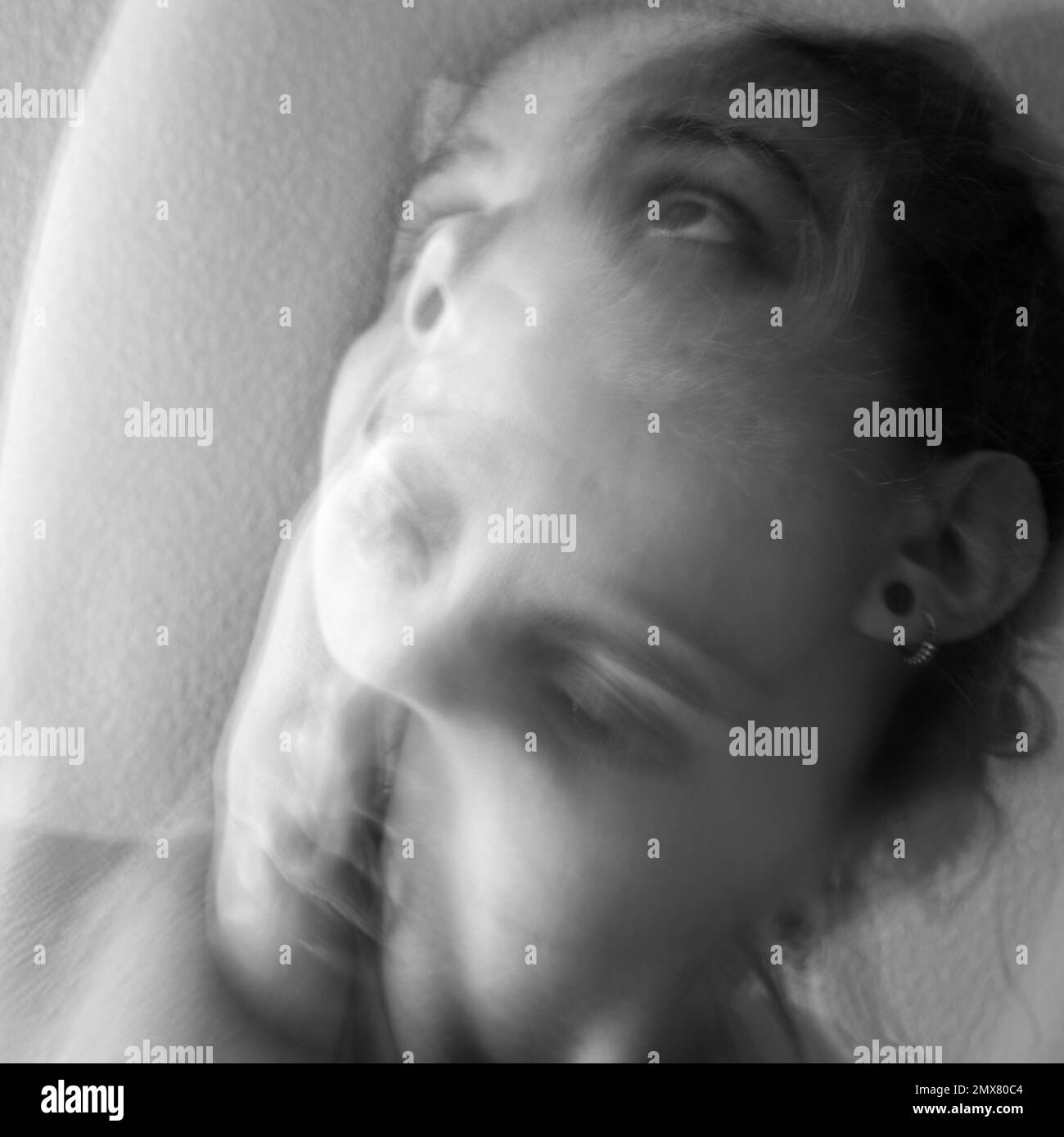 Double exposure black and white young female looking up and down while ...