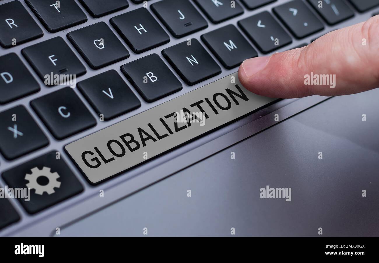 Hand writing sign Globalization. Word for development of an ...