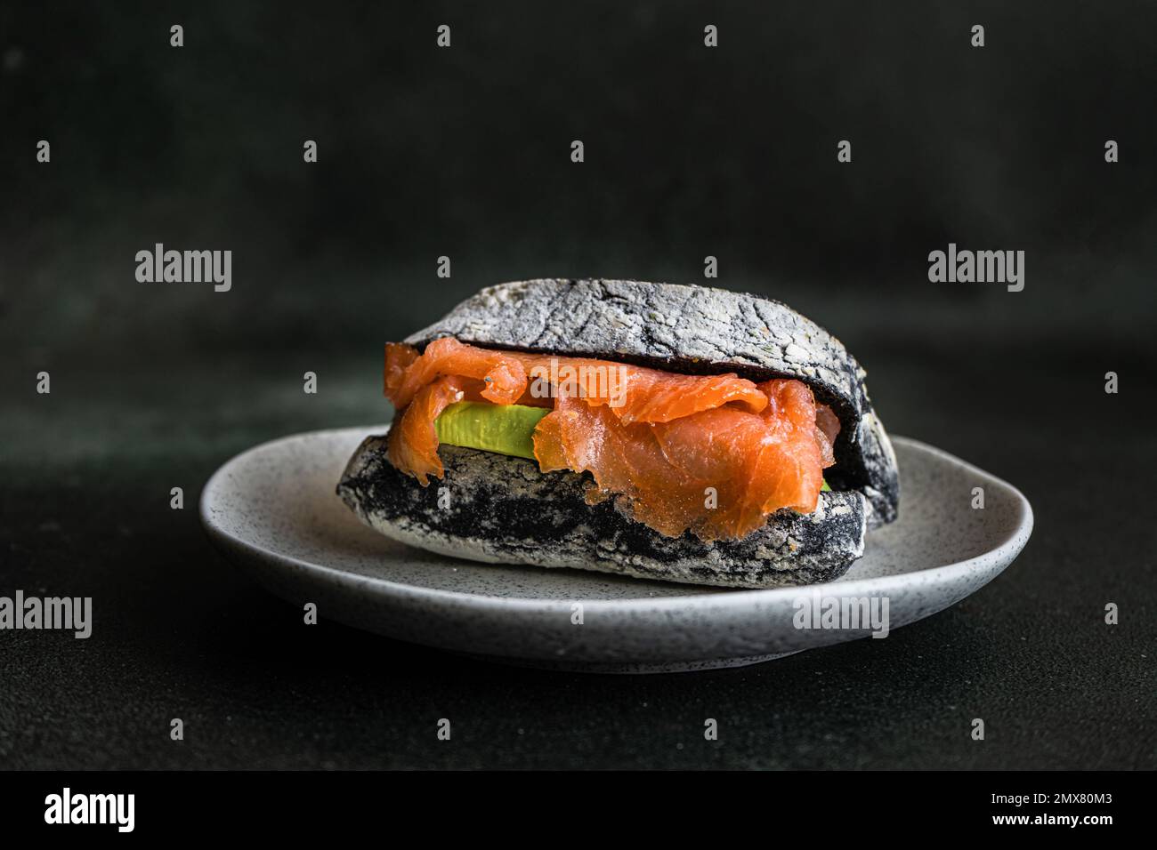 Healthy snack with sour dough and activated carbon bun and salmon fish in sandwich Stock Photo ...