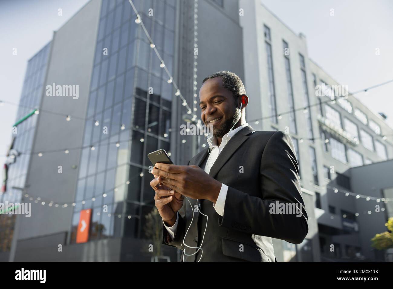 Photo from below. African American businessman in a suit standing ...
