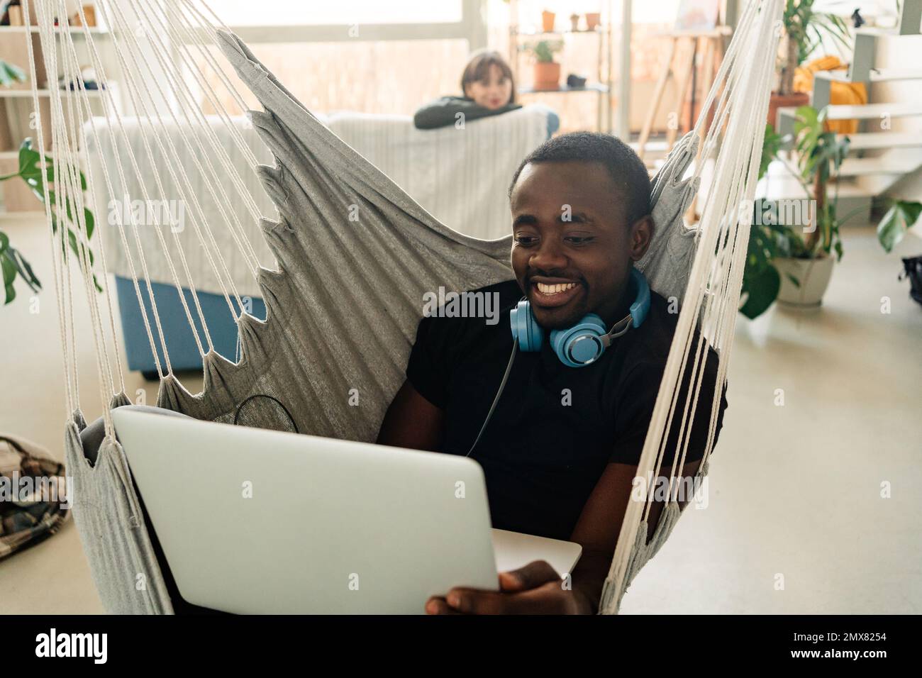 High angle of cheerful African American male freelancer in casual ...