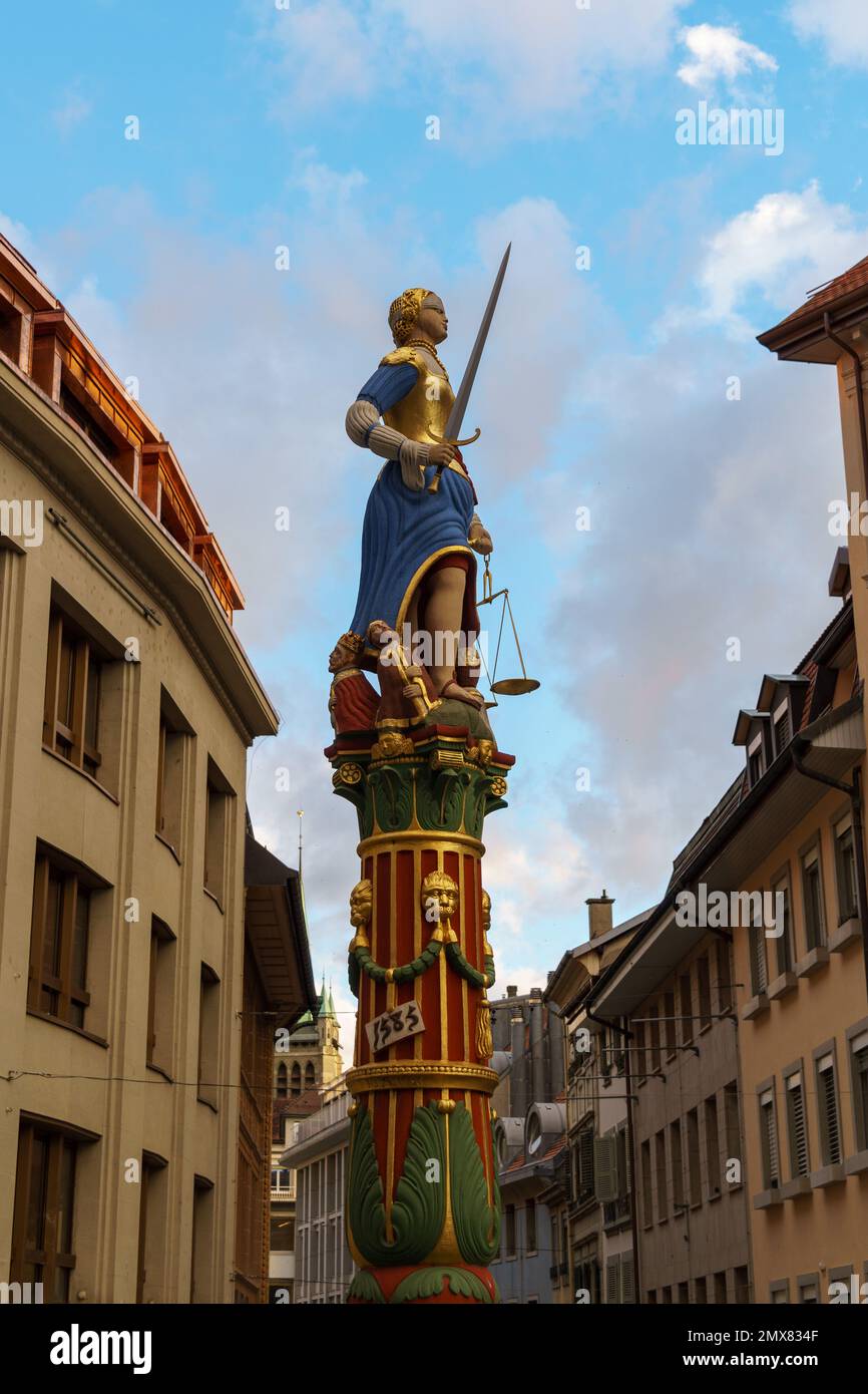 The lady justice statue with raised sword between buildings in Lausanne ...
