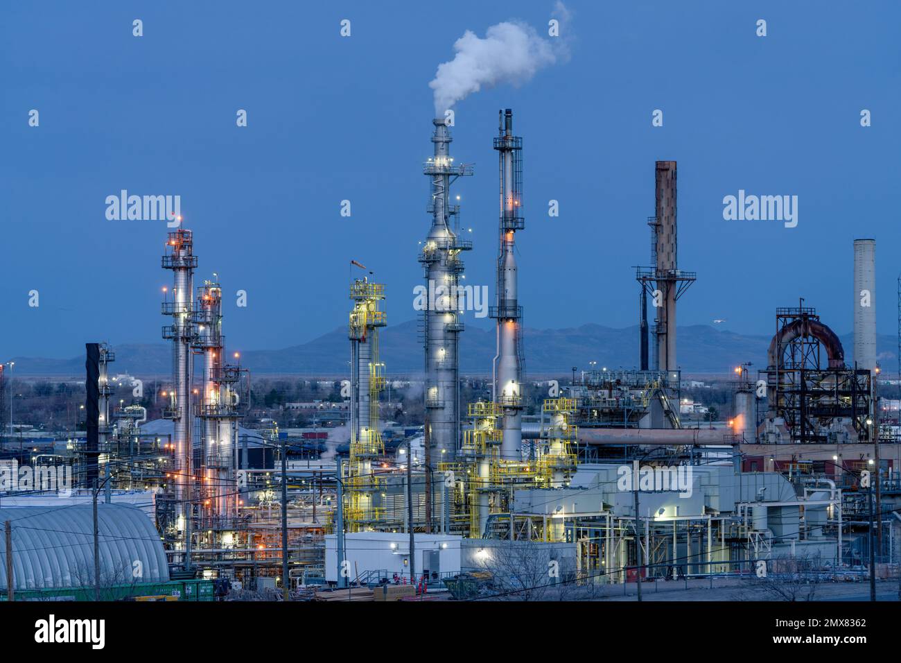 An oil refinery lit up in pre-dawn twilight near Salt Lake City, Utah ...