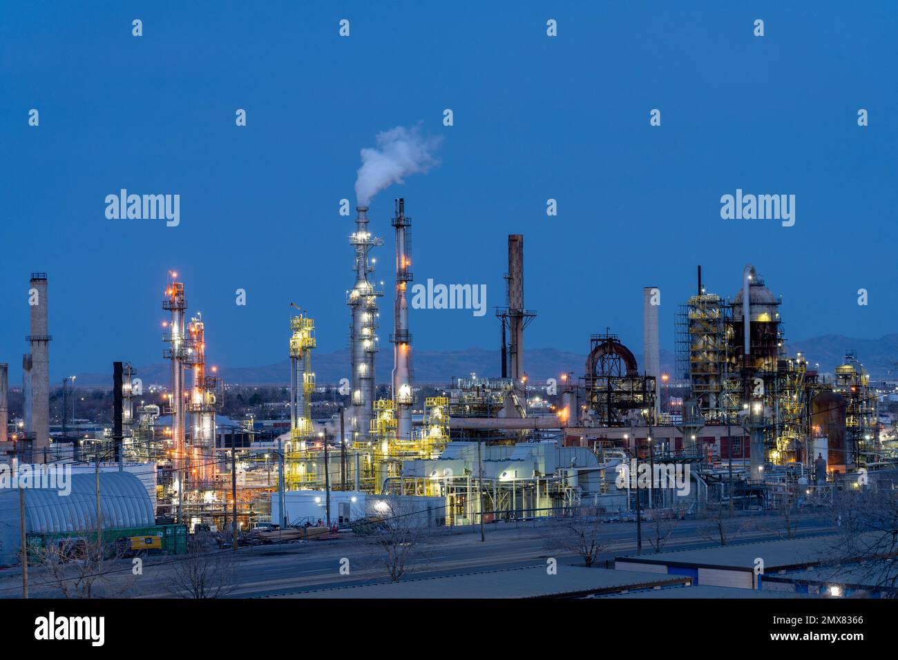 An oil refinery lit up in pre-dawn twilight near Salt Lake City, Utah ...