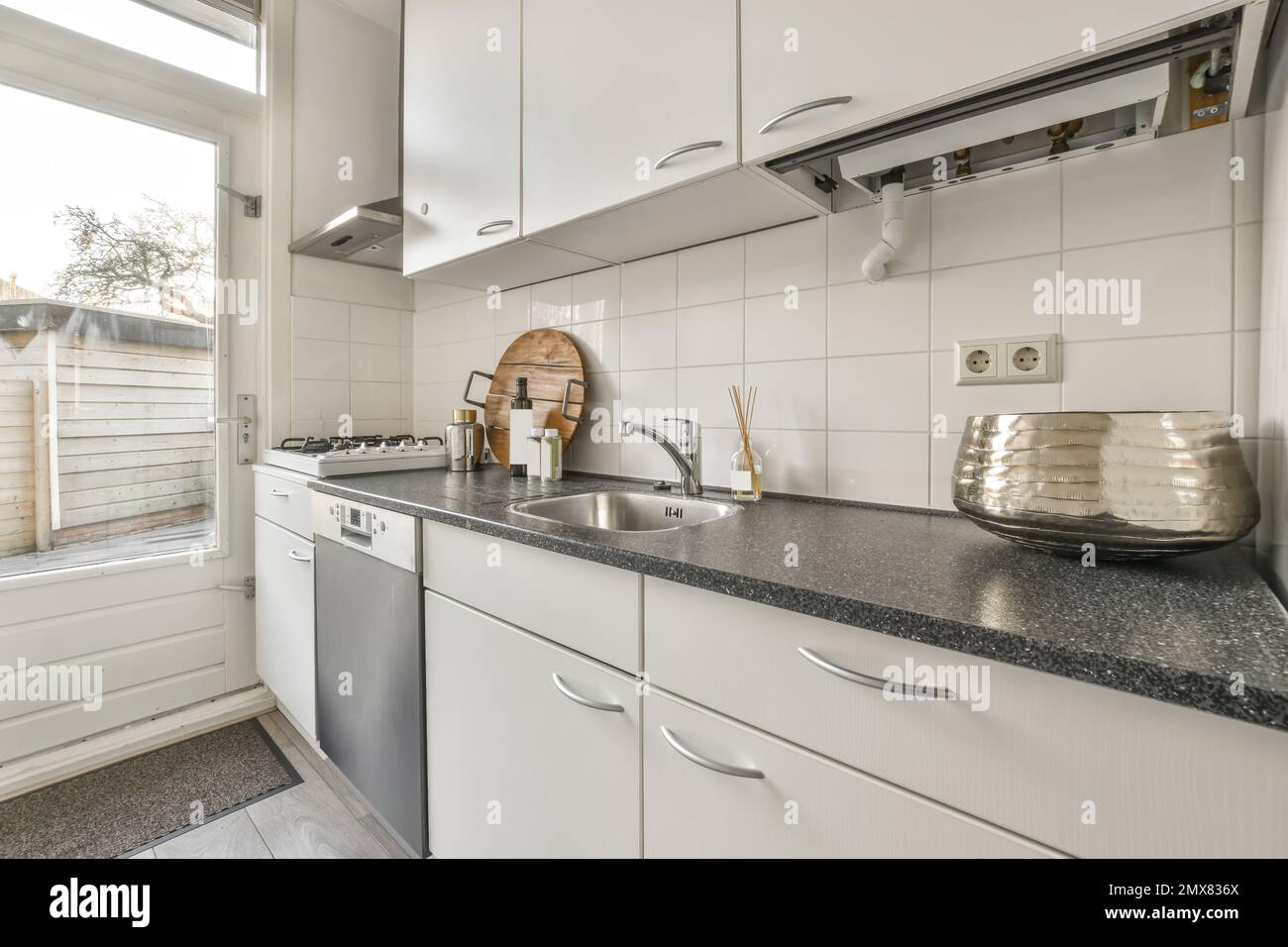 Contemporary kitchen interior with sink and built in stove and washing ...