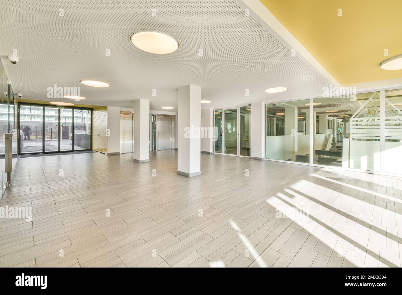 Interior of spacious empty hall with columns and panoramic windows in ...