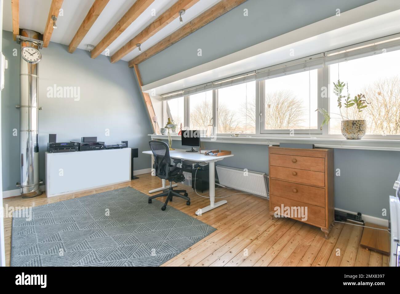 Interior of modern office room with wooden floor and desk with computer ...