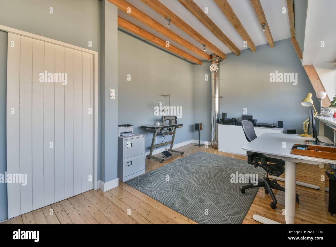 Interior of modern office room with wooden floor and desk with computer ...