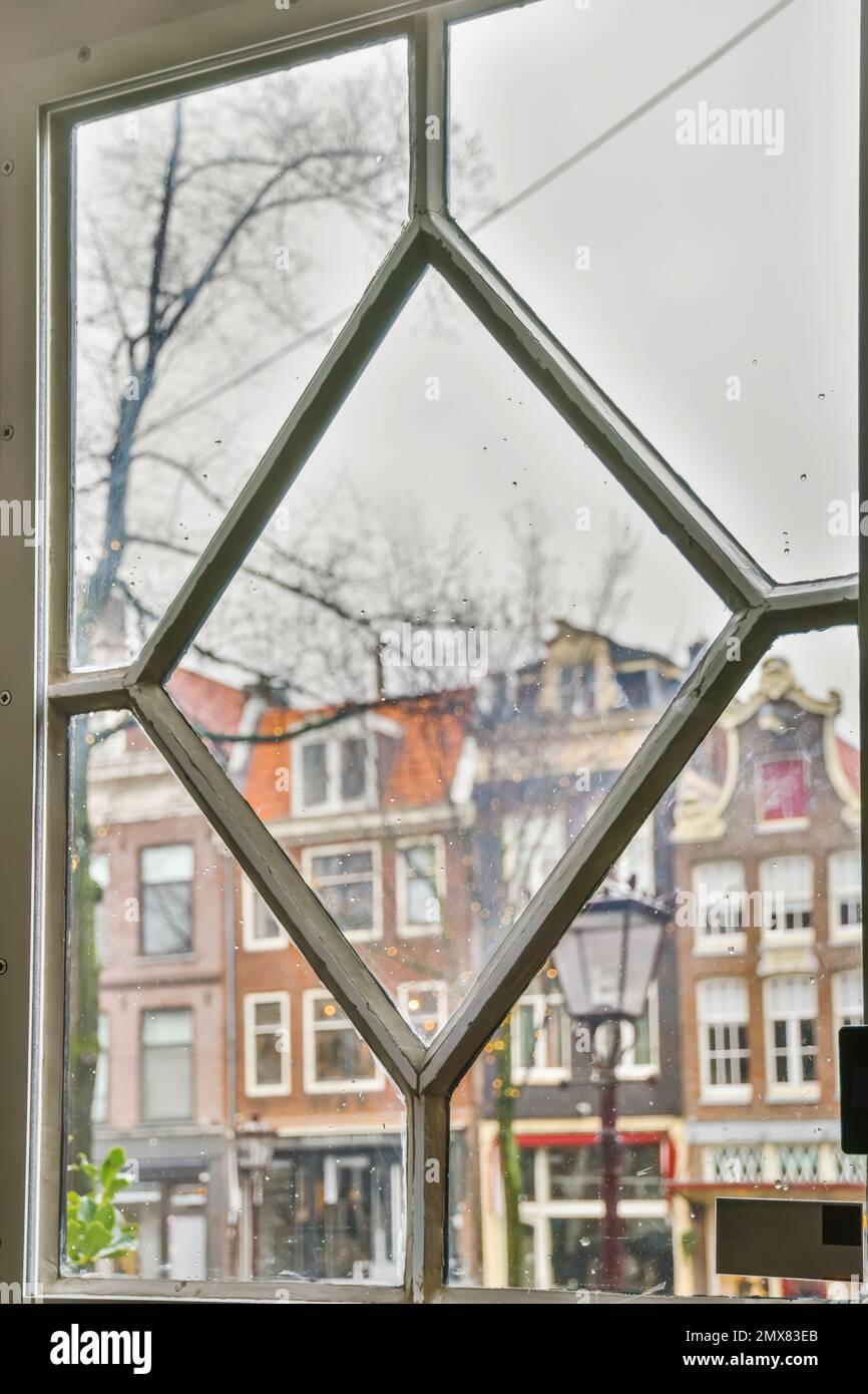 Through glass window view of old residential buildings in town in ...