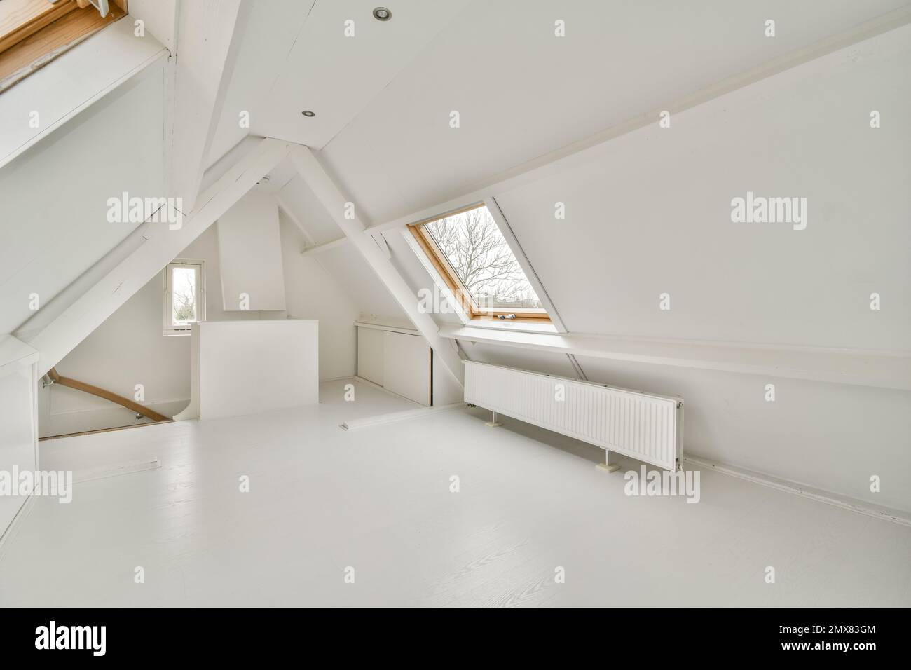 Interior design of empty minimalist style attic room with white walls ...